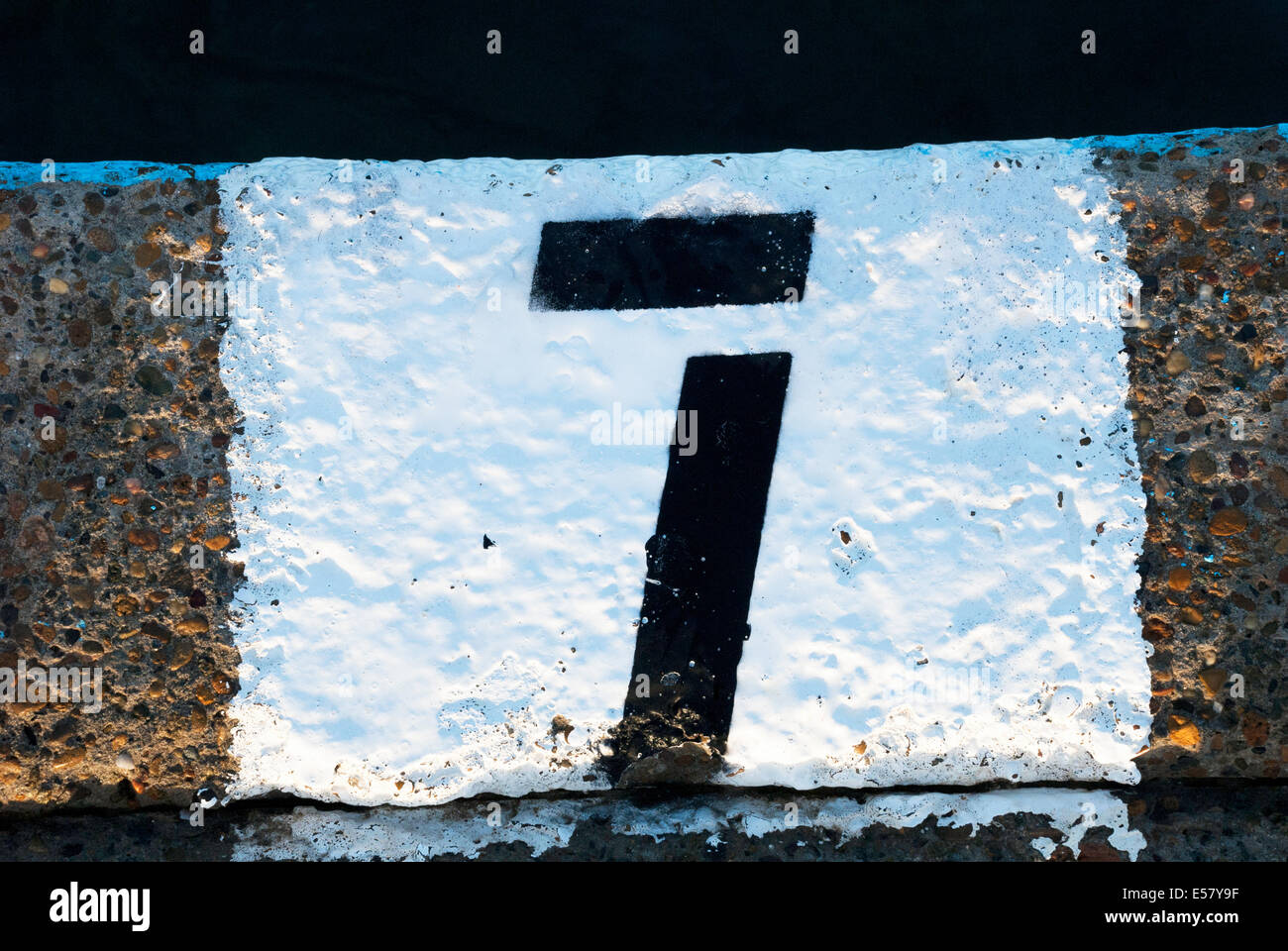 Number seven, stencilled in black paint on white square Stock Photo - Alamy
