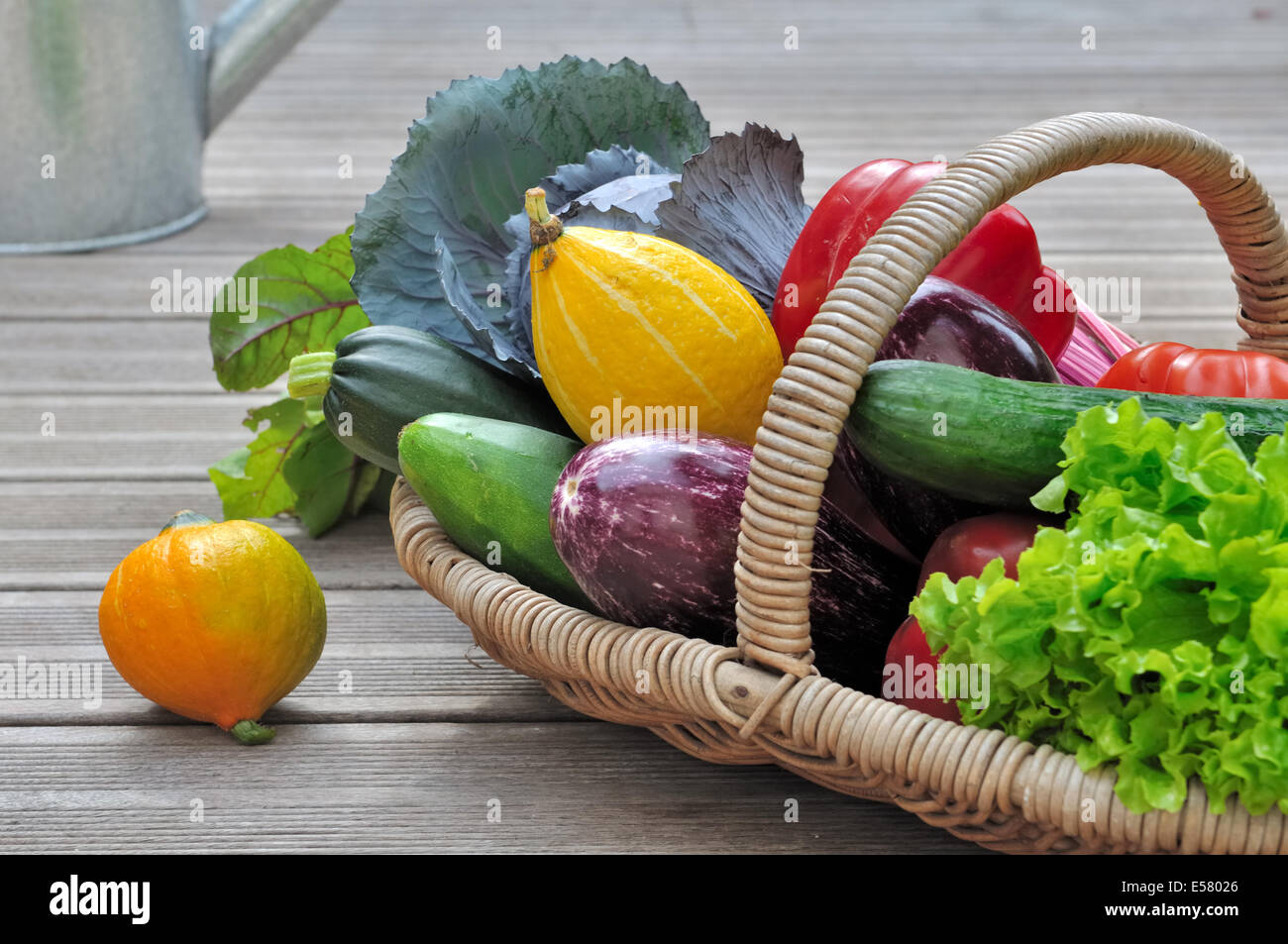 Fresh summer vegetables in a basket placed on a wood floor Stock Photo ...