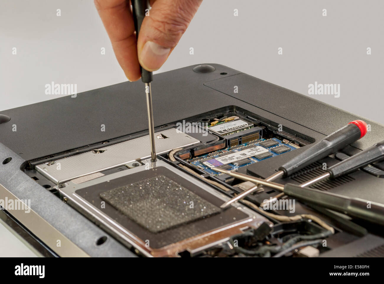 man fixing computer or laptop or notebook with crewdriver Stock Photo ...