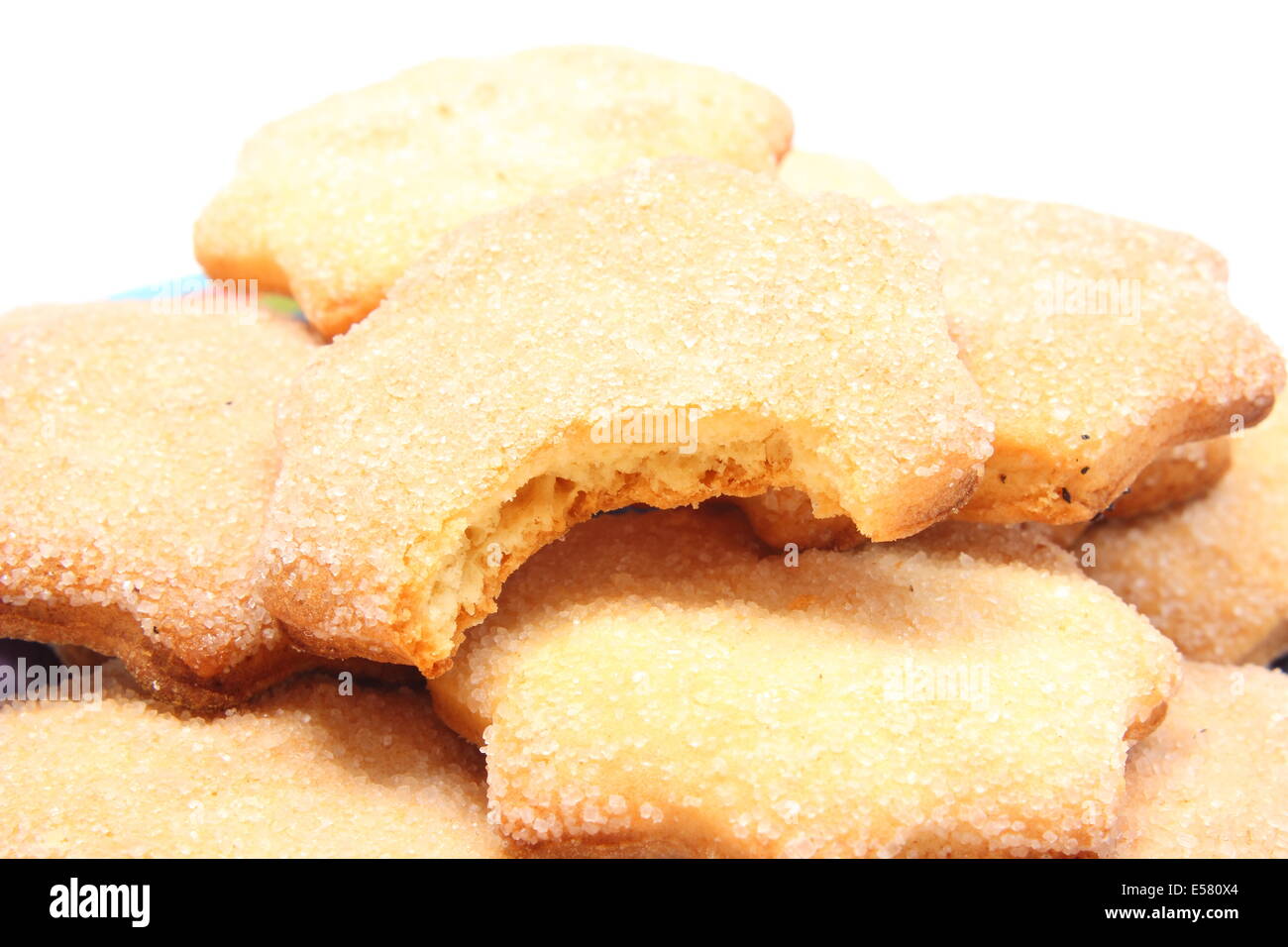 Bitten homemade cake lying on heap of delicious cookies with sugar ...