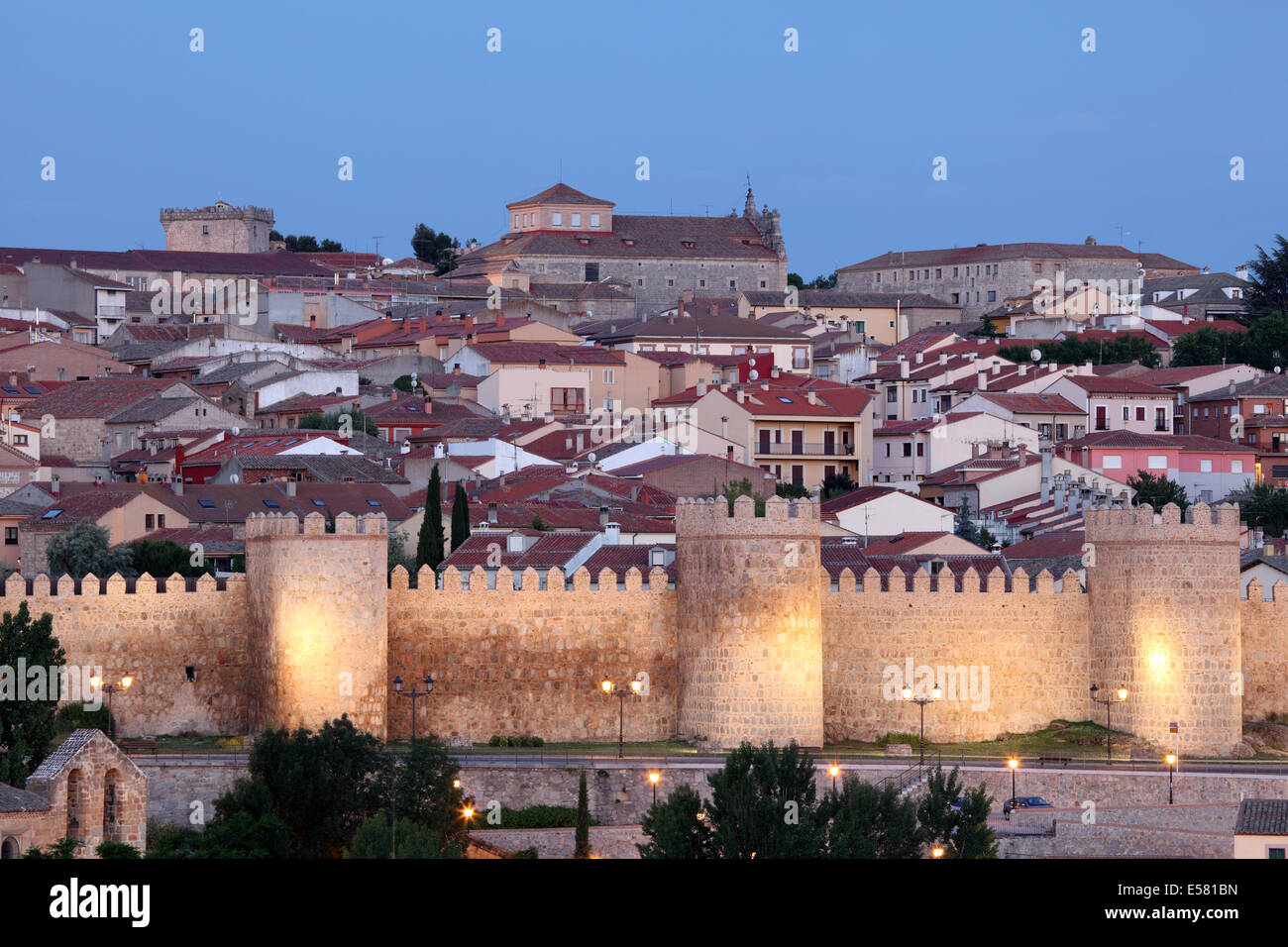 Medieval city walls of Avila illuminated at dusk. Castile and Leon ...