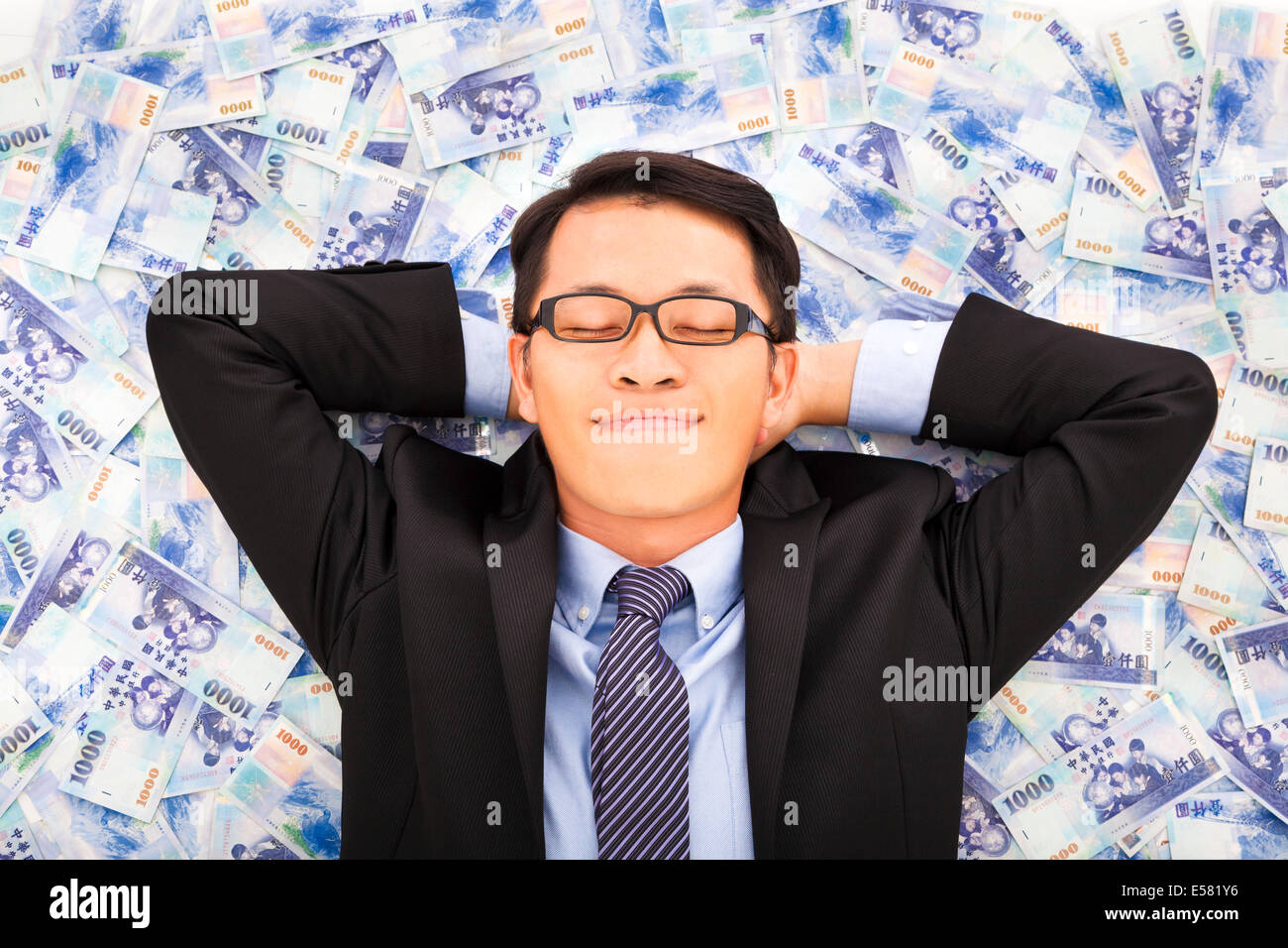 business man enjoying and lying on the stacks of money Stock Photo - Alamy
