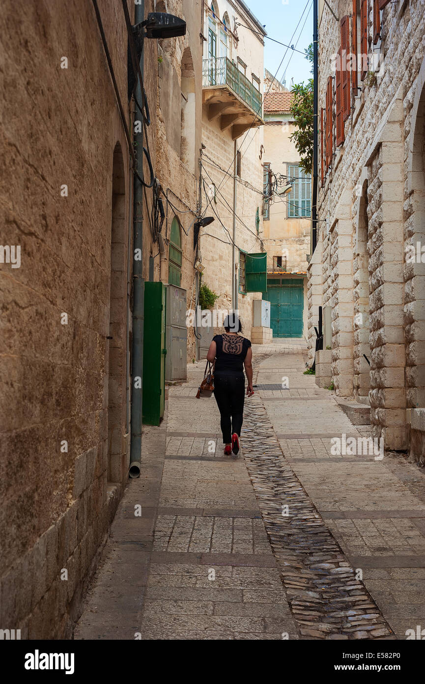 A woman walks down an alleyway in the old city, Nazareth, Israel Stock ...