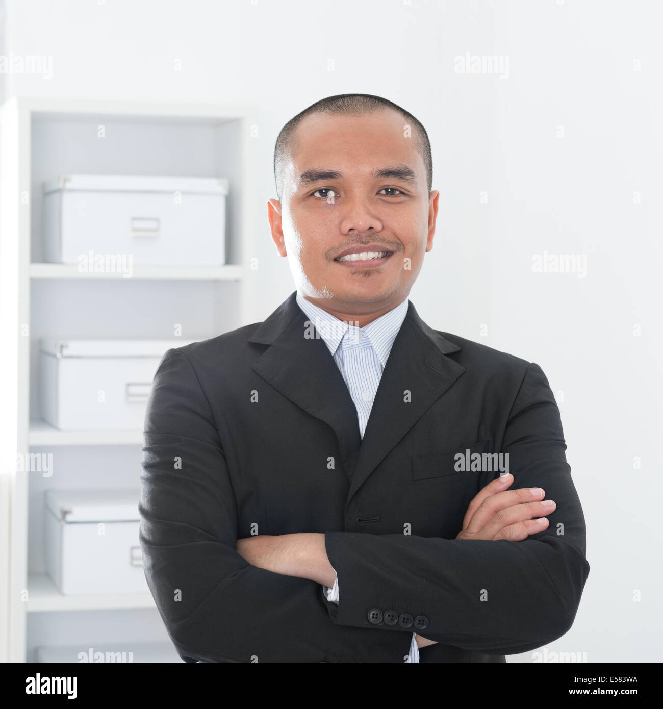 Portrait of 30s Asian Muslim business man smiling, real modern office ...