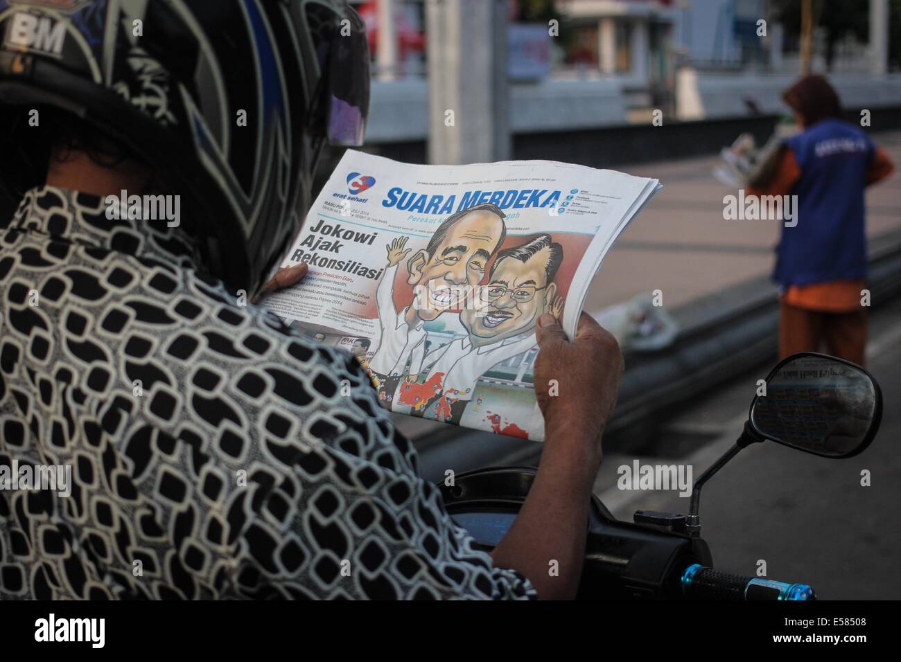 Semarang, Central Java, Indonesia. 23rd July, 2014. A man reads a ...