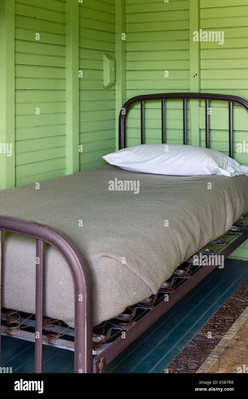 Simple bed in basic room Stock Photo - Alamy
