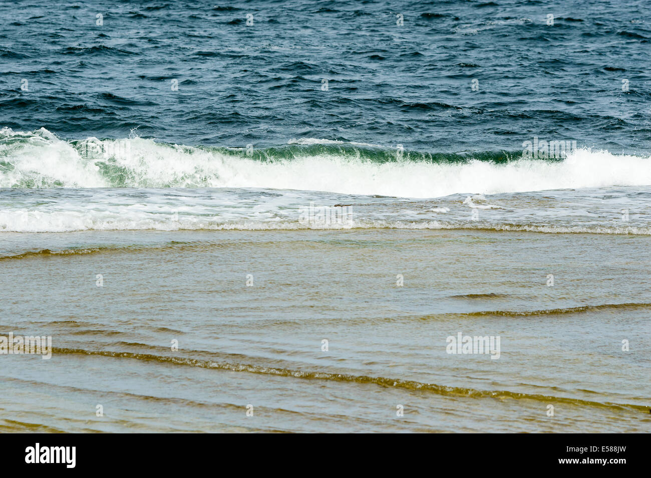 Small summer waves hitting limestone beach while breaking Stock Photo ...