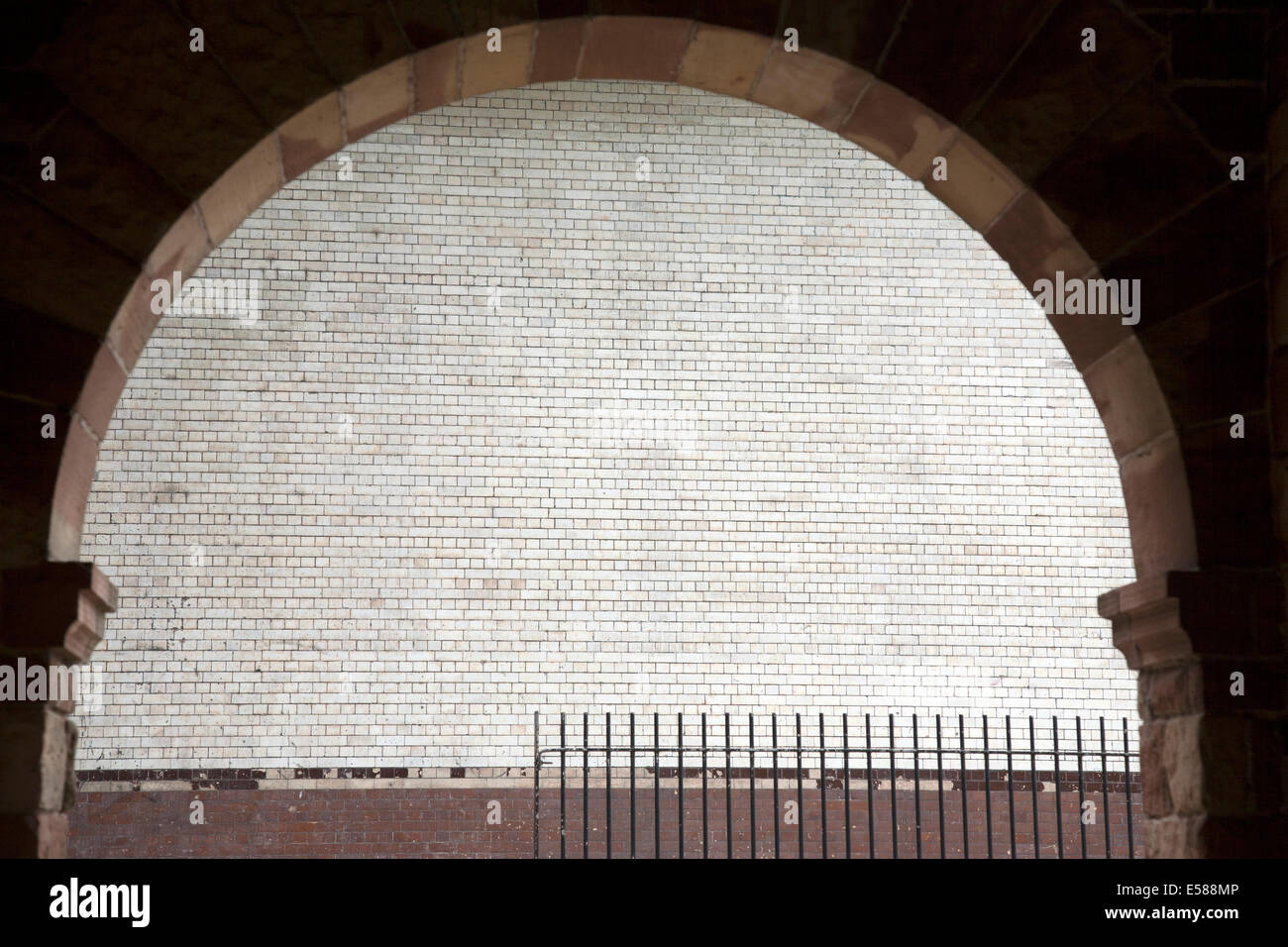 White Urban Wall through Arch Stock Photo - Alamy
