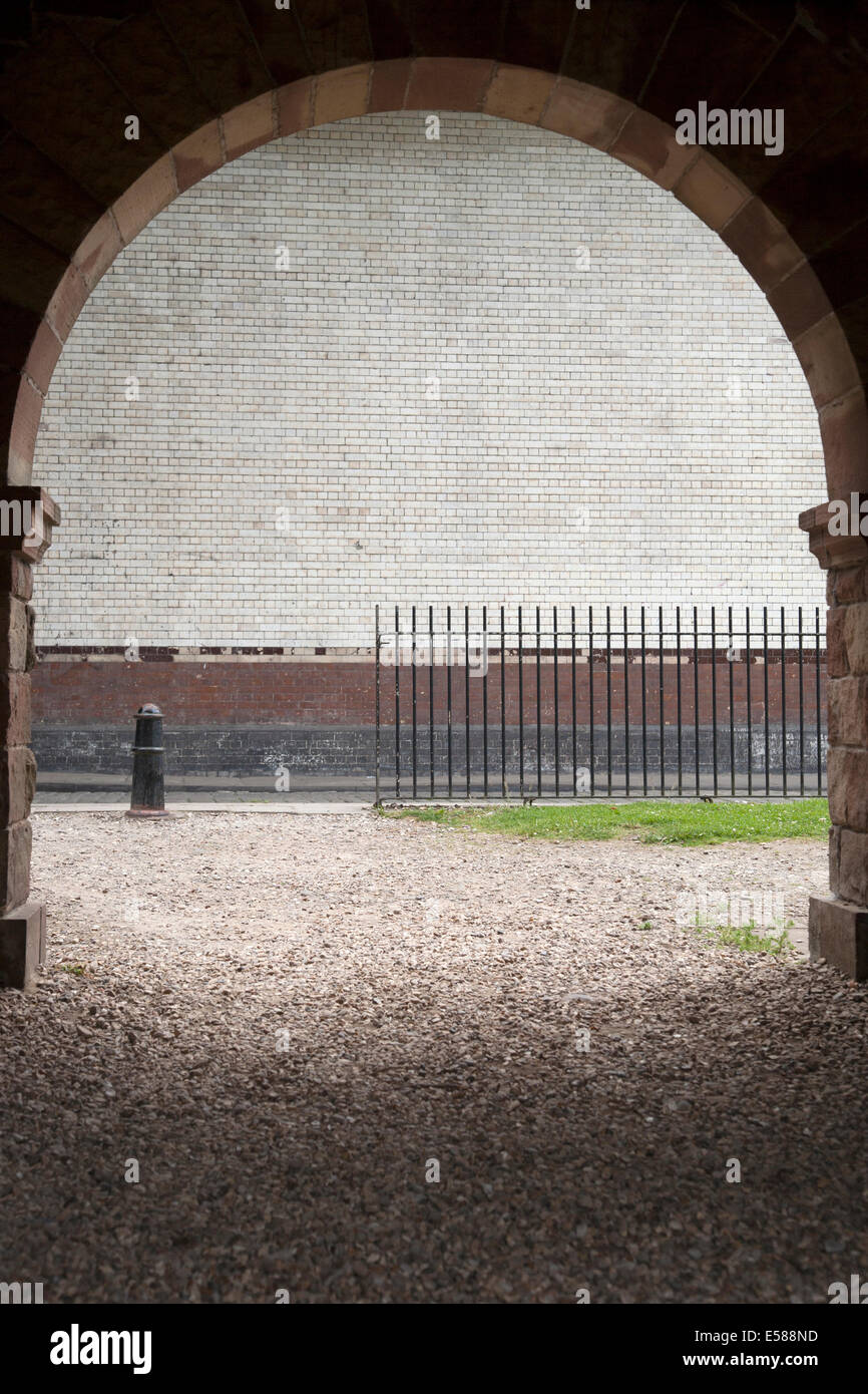 White Urban Wall through Stone Arch Stock Photo - Alamy