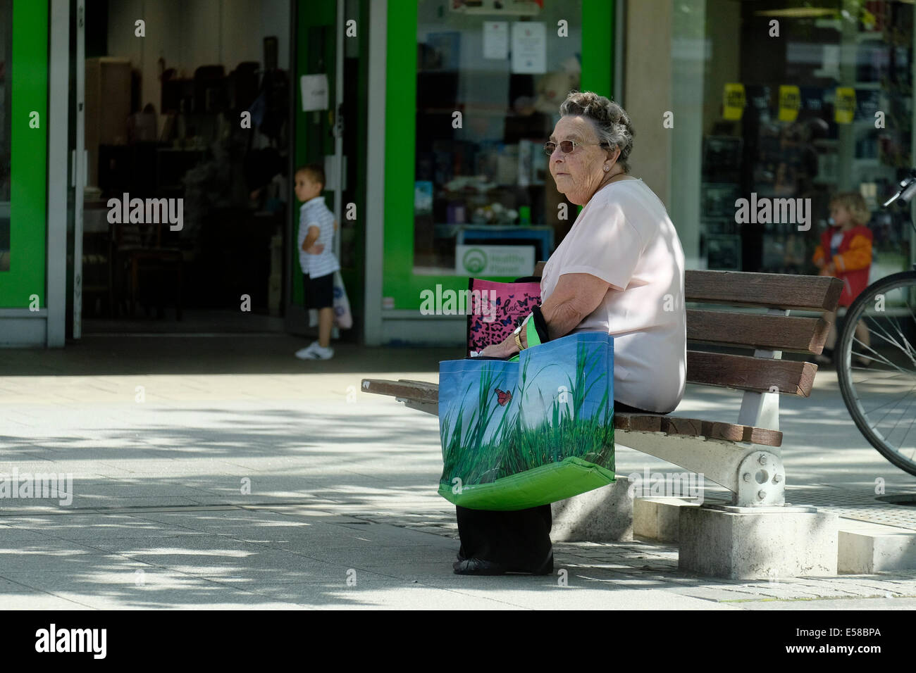 A senior citizen sitting on a bench Stock Photo - Alamy