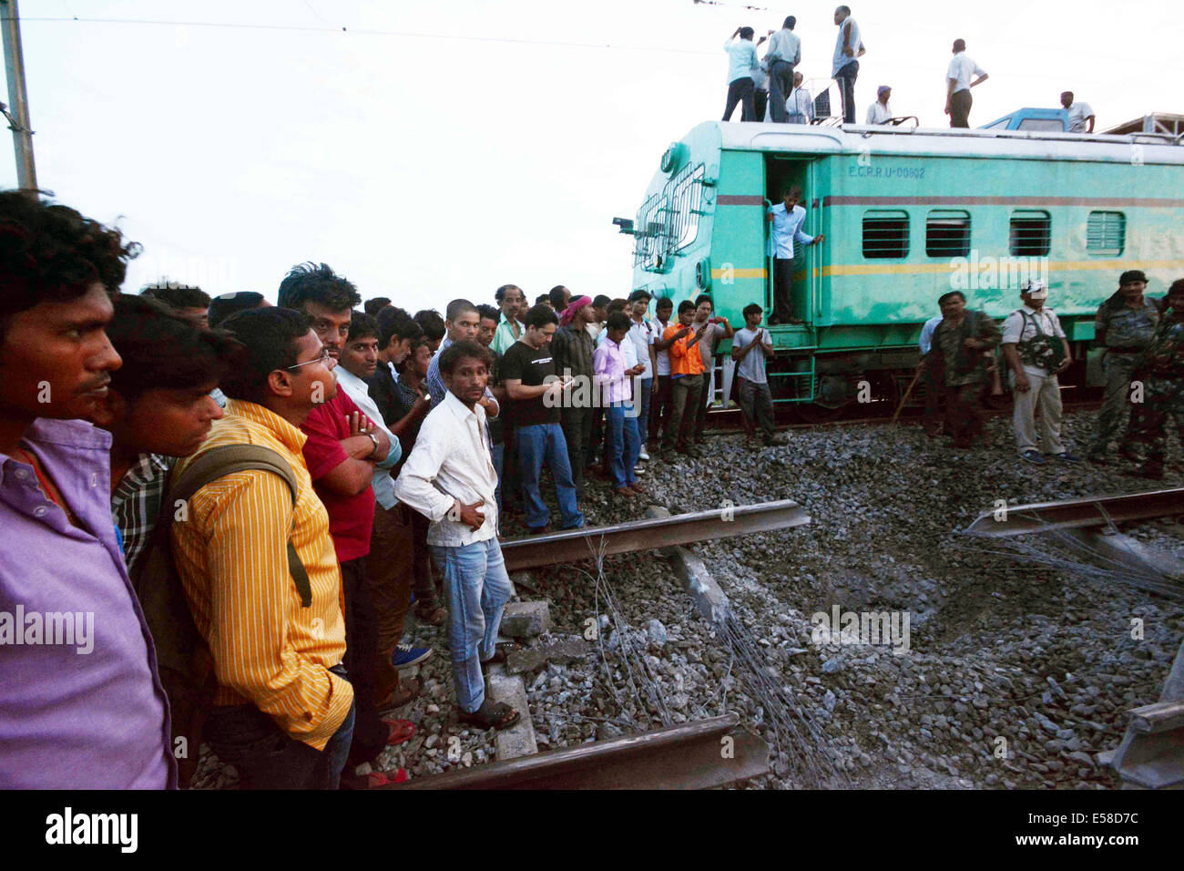 Rafiganj, India. 23rd July, 2014. People stand next to the damaged ...