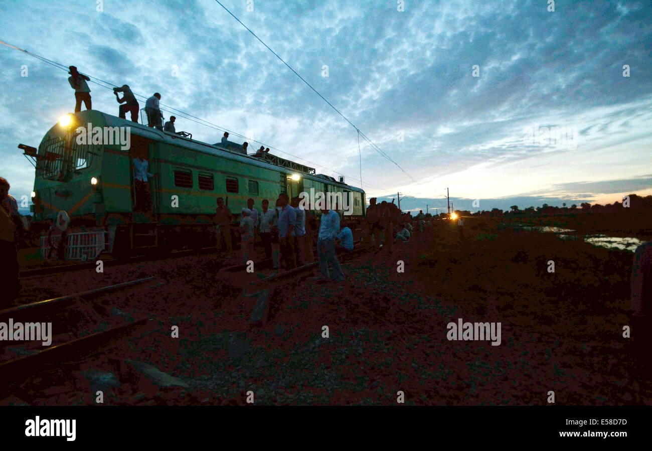 Rafiganj, India. 23rd July, 2014. People stand next to the damaged ...
