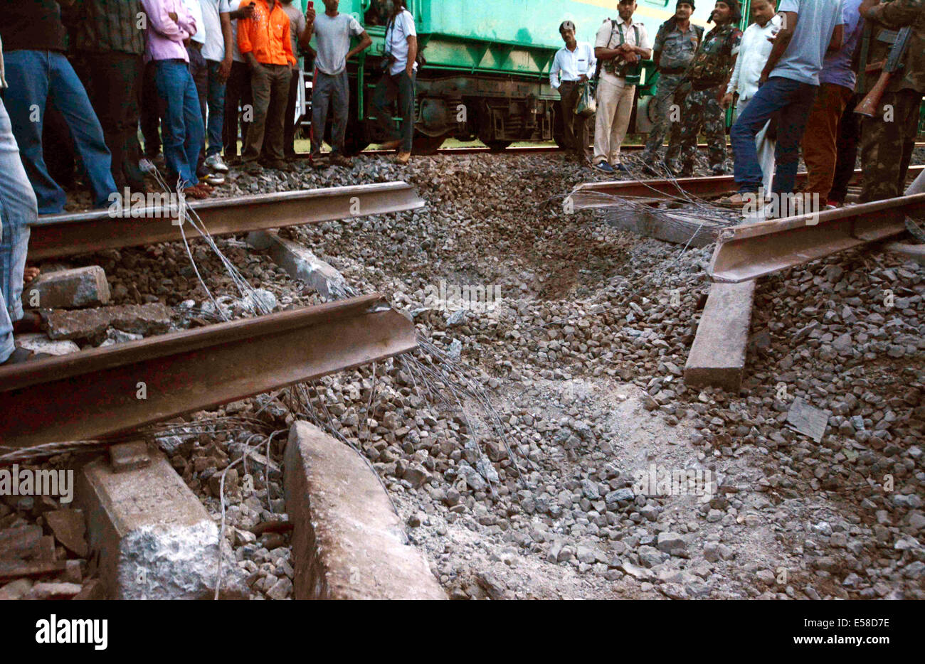 Rafiganj, India. 23rd July, 2014. People stand next to the damaged ...