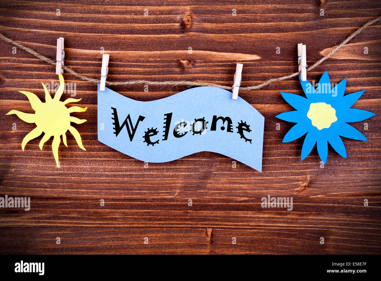 Purple Label with the Word Welcome, Hanging on a Line with a Sun and a ...