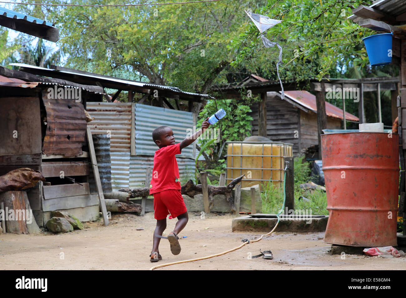boy withe a paper kite in a poor village of the maroon tribe in the ...