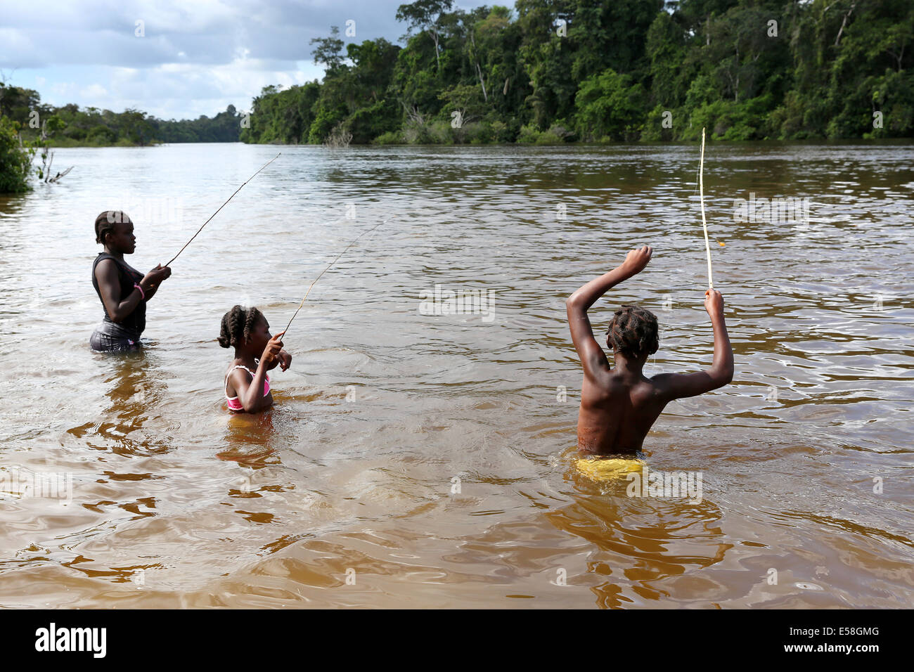 Children fishing in the river of Suriname, Suriname, Latin America ...