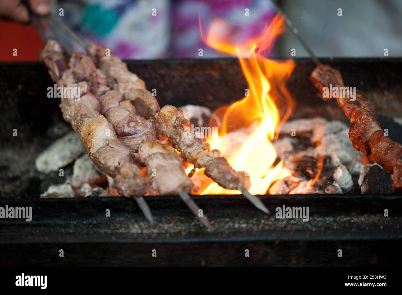 Flames grilling mutton skewers Stock Photo - Alamy
