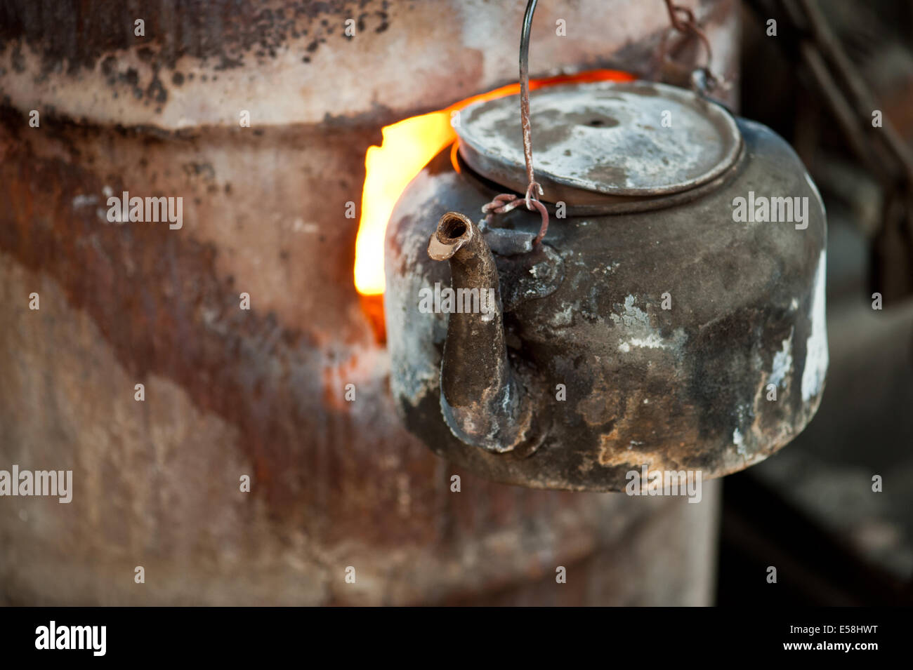 Flames boiling water in a sooty kettle at Muslim Street market in Xian ...