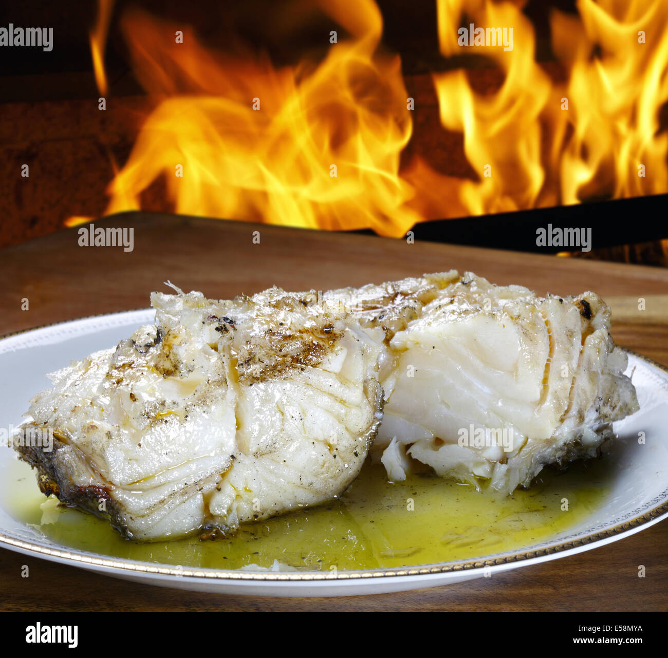 Baked cod with olive oil Stock Photo - Alamy