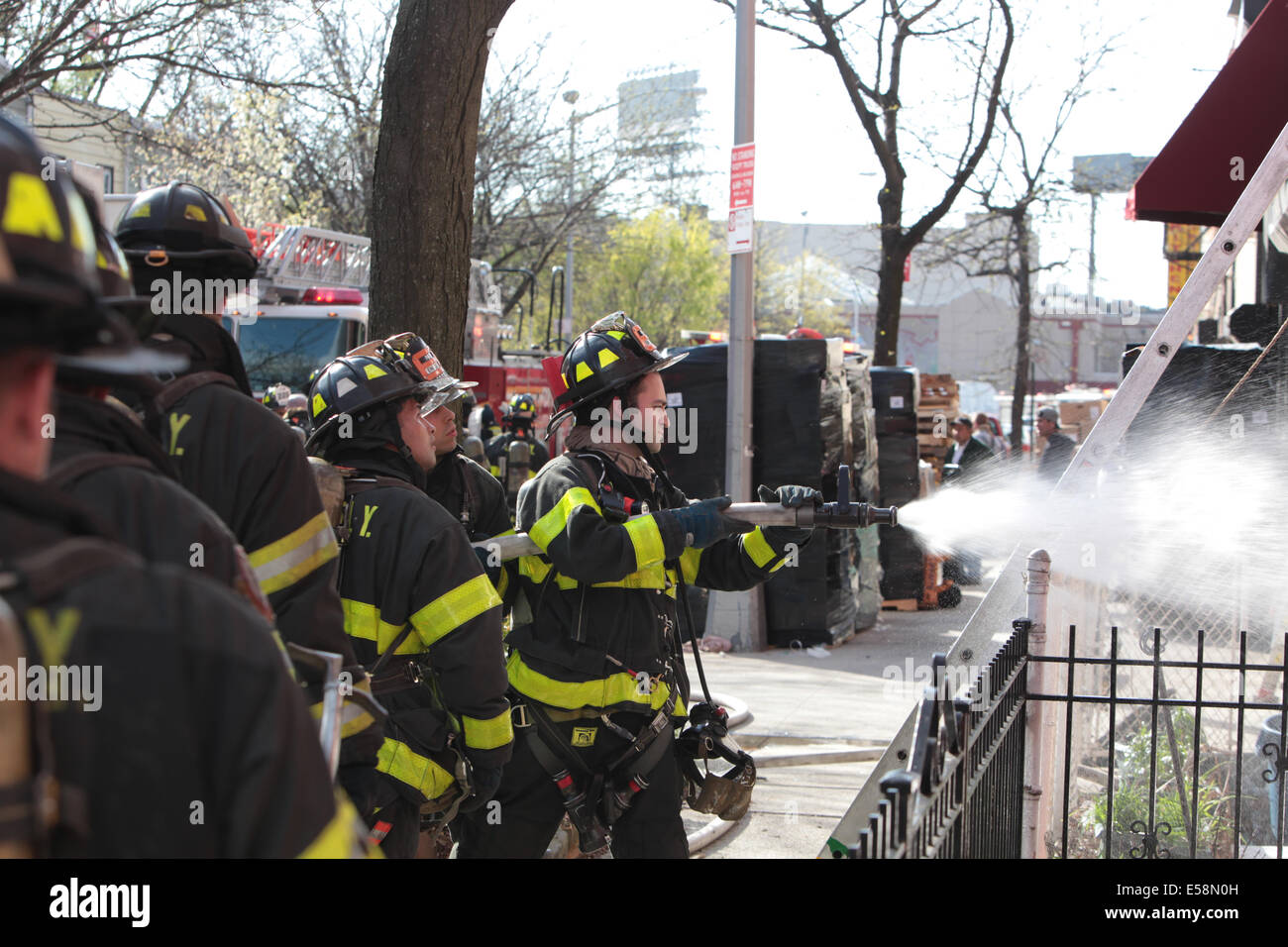 New York City - FDNY firefighters spray water on residential fire in ...