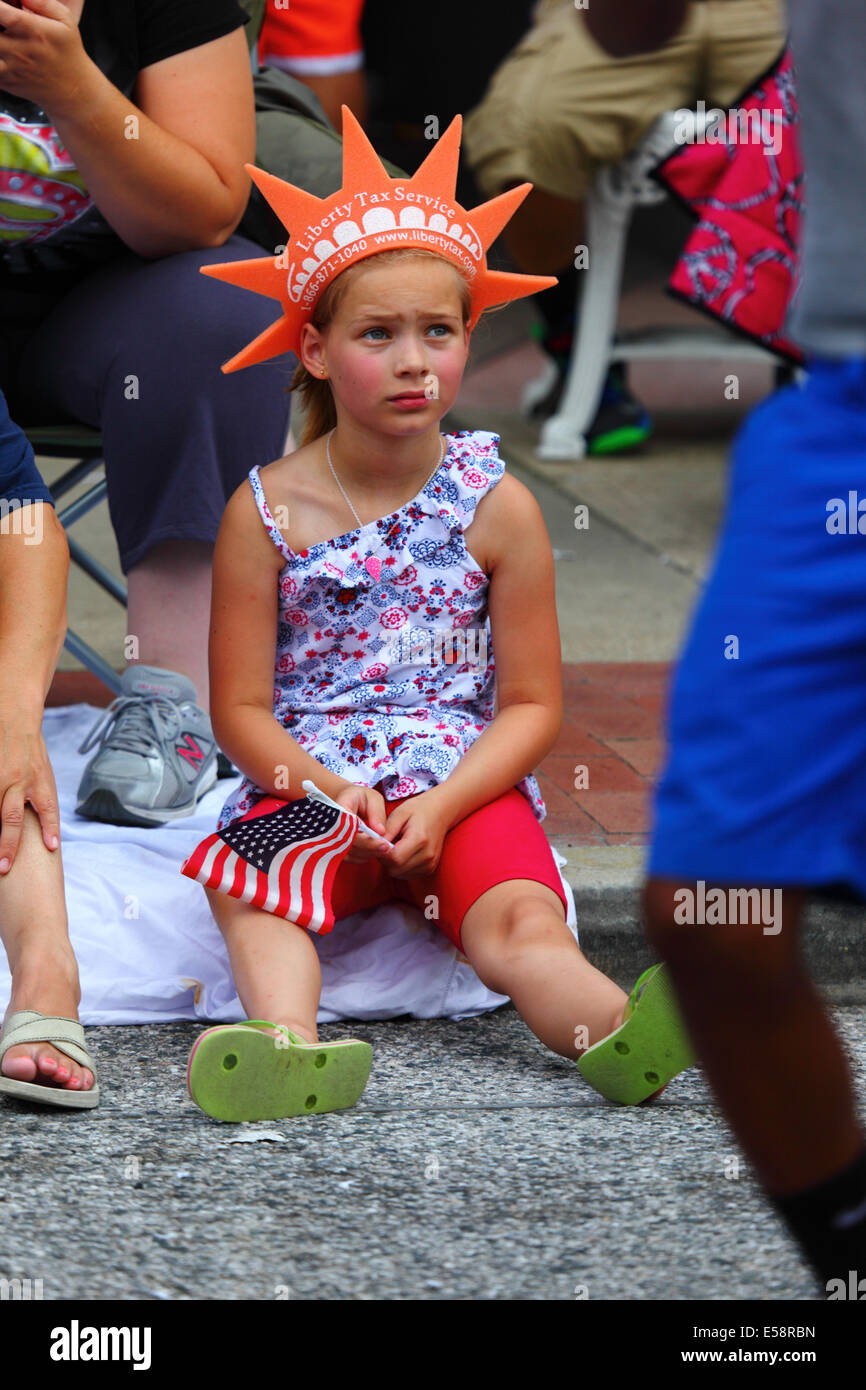 Caucasian girl in crowd wearing Statue of Liberty headgear during 4th ...