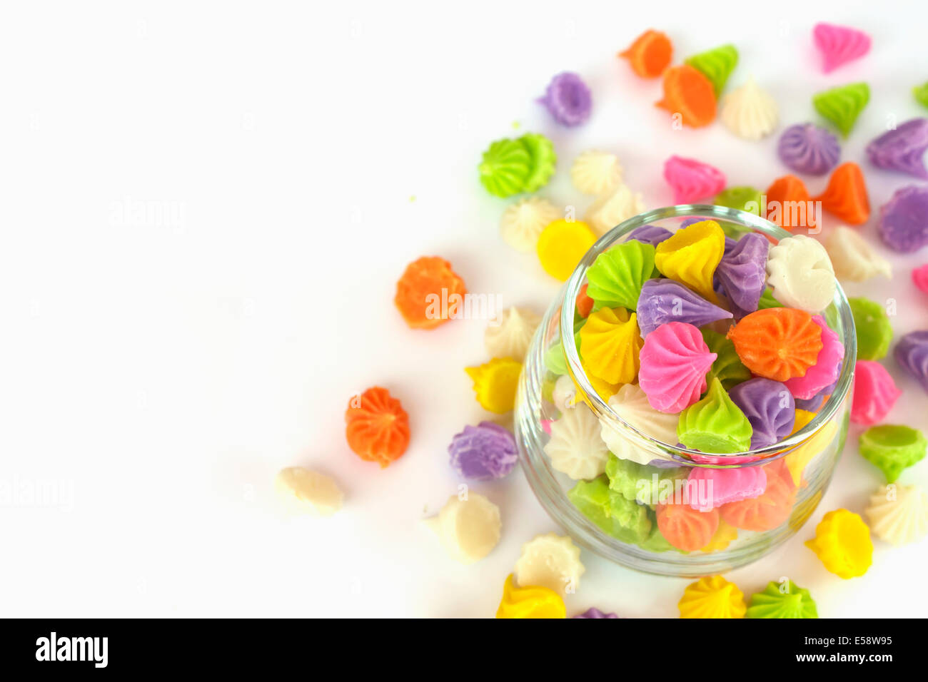 Colorful candy in glass saucer and bowl isolated on white background ...