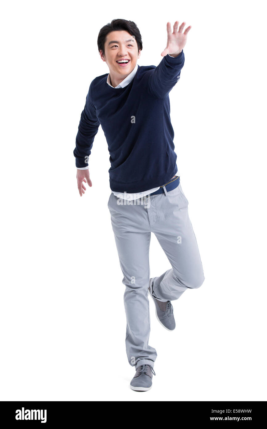 Excited young man running Stock Photo - Alamy