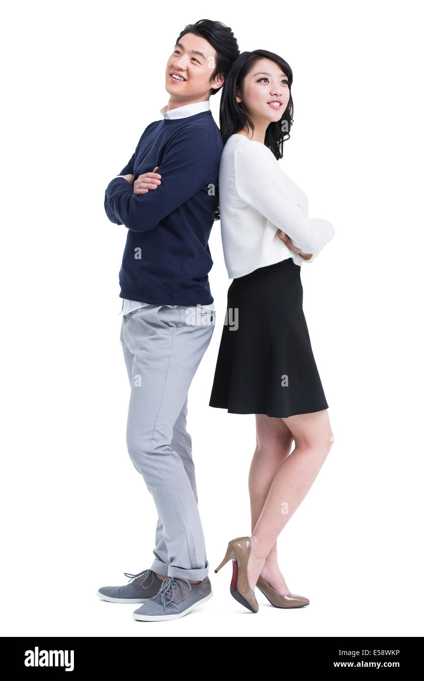 Portrait of sweet young couple back to back Stock Photo - Alamy