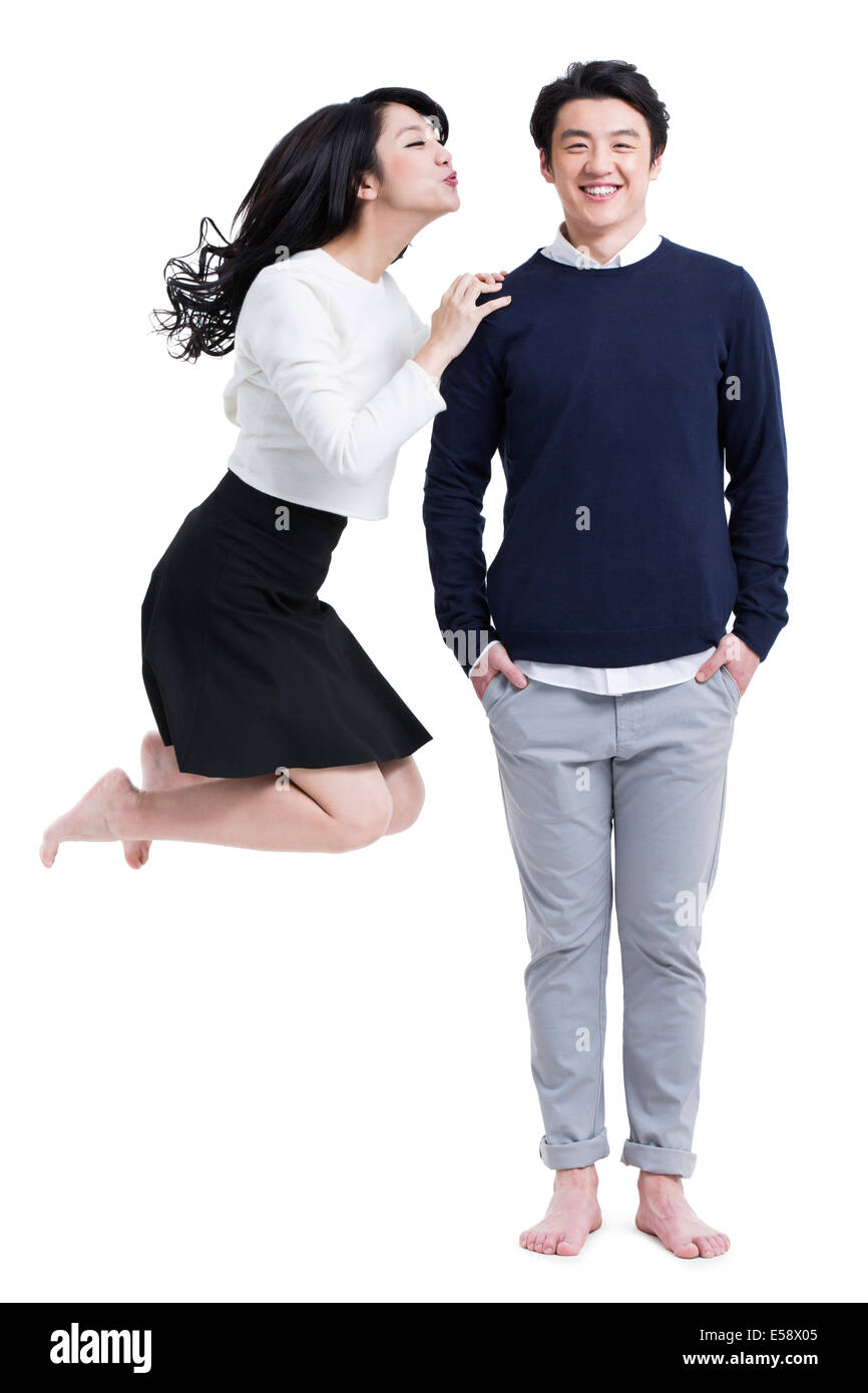Happy young couple jumping Stock Photo - Alamy