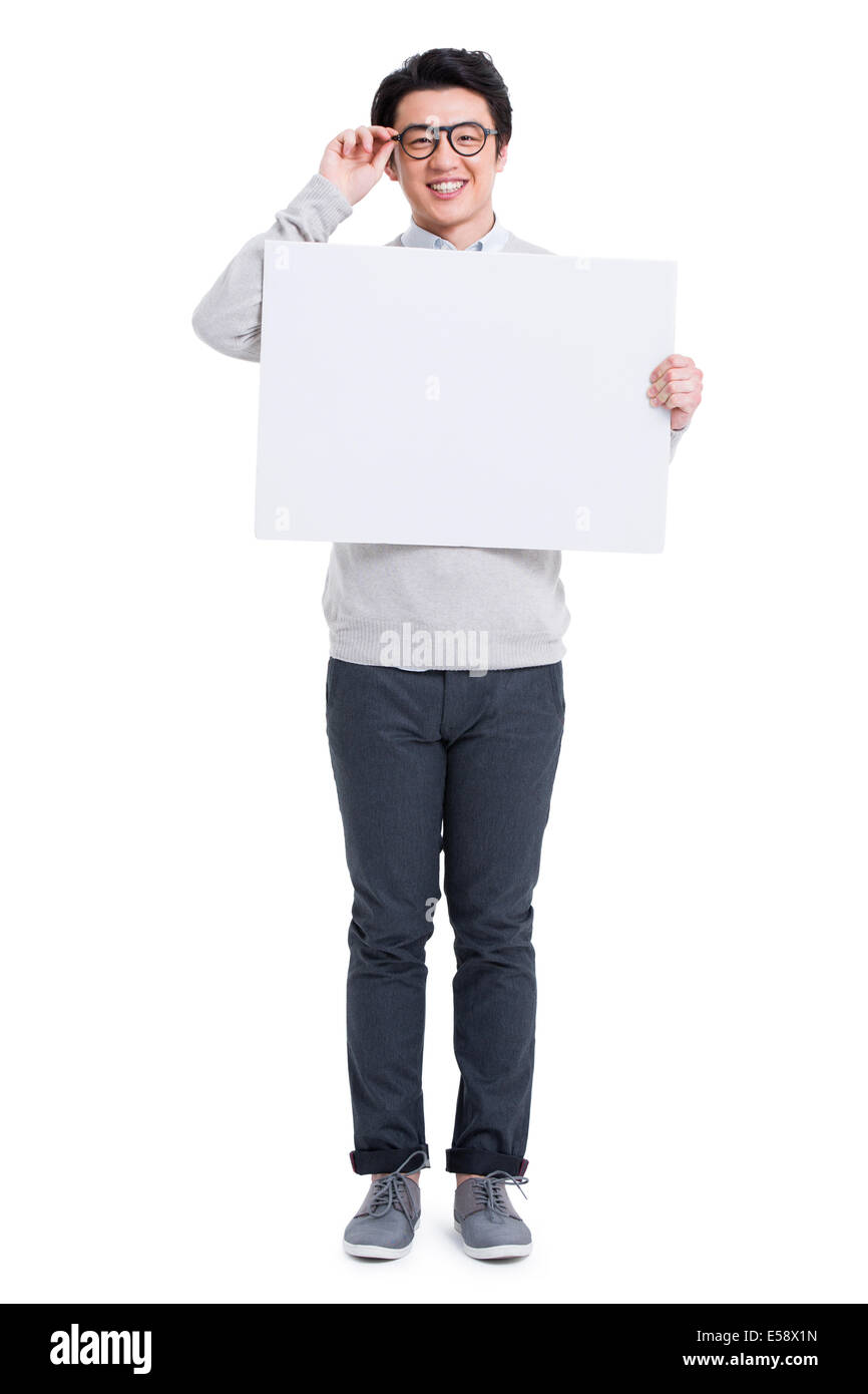 Cheerful young man holding whiteboard Stock Photo - Alamy
