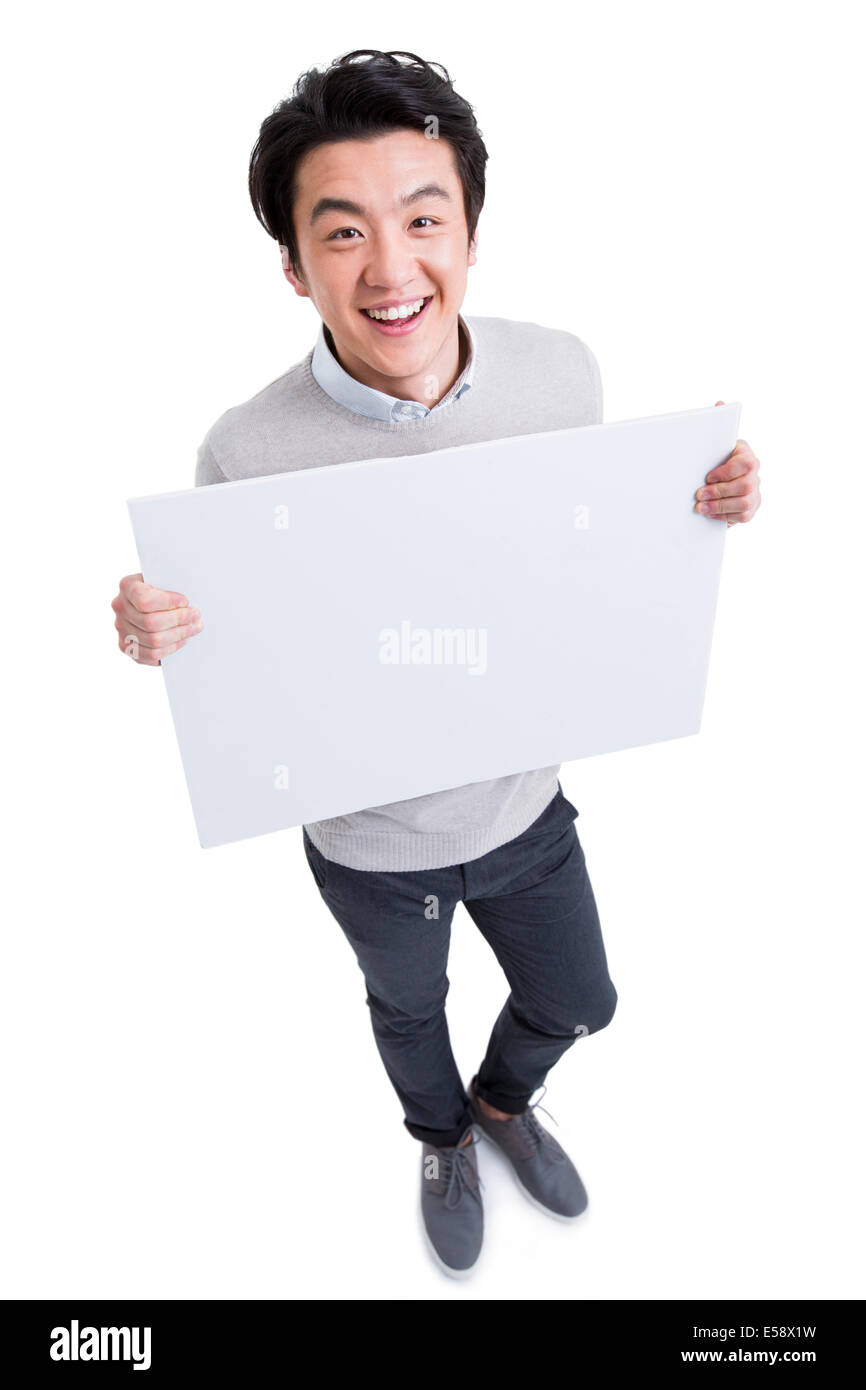 Cheerful young man holding whiteboard Stock Photo - Alamy