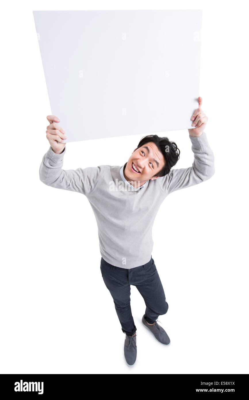 Cheerful young man holding whiteboard Stock Photo - Alamy