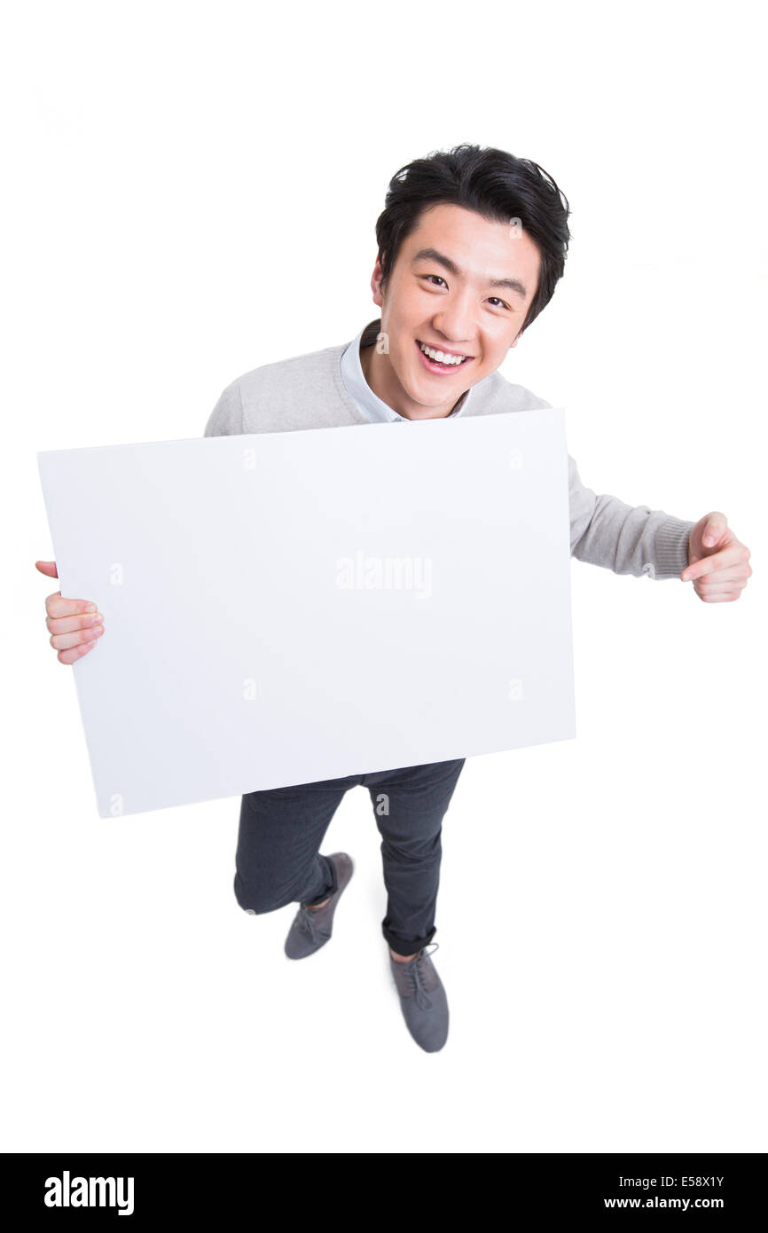 Cheerful young man holding whiteboard Stock Photo - Alamy