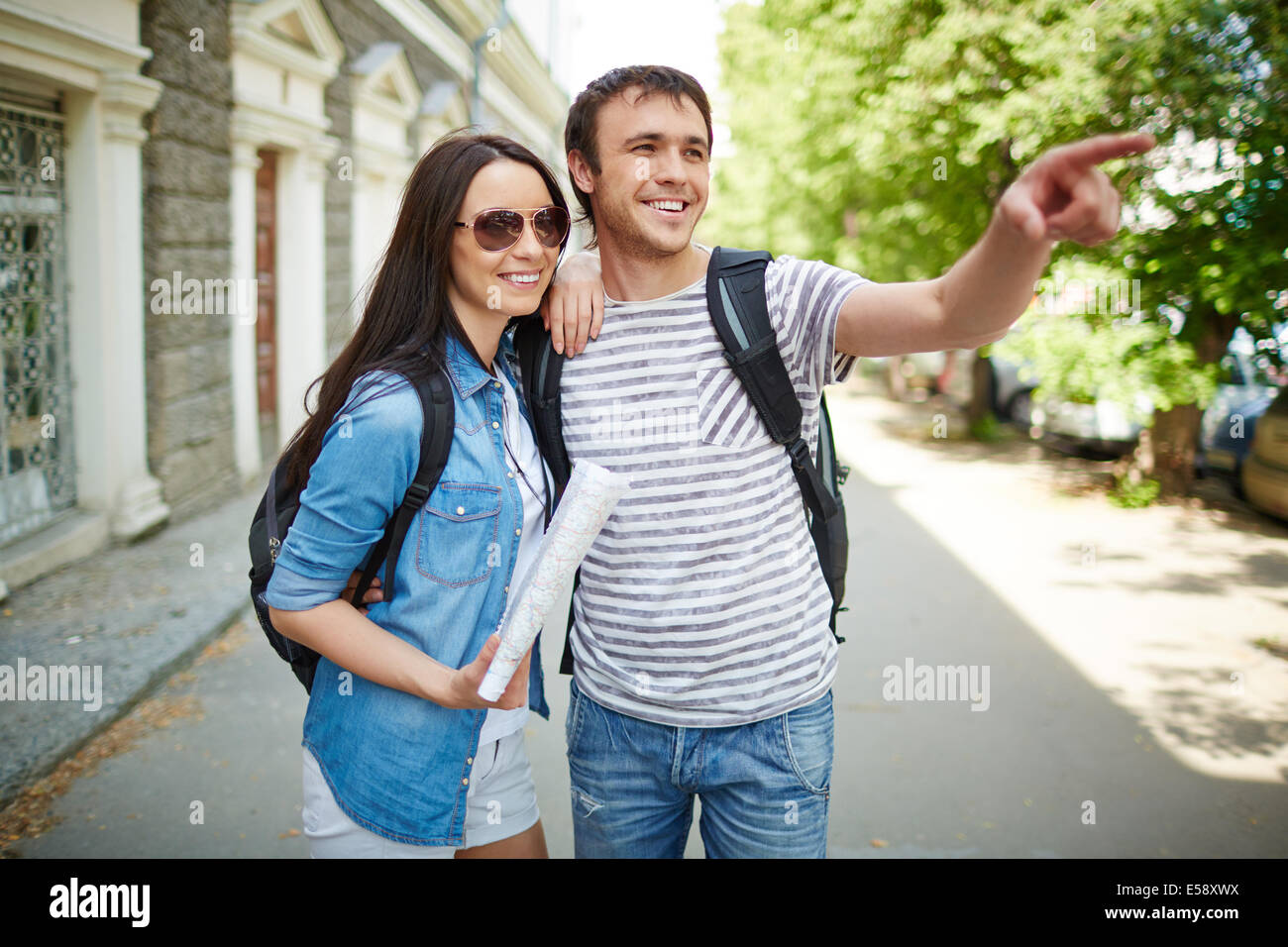 Couple of young travelers taking walk during journey Stock Photo - Alamy