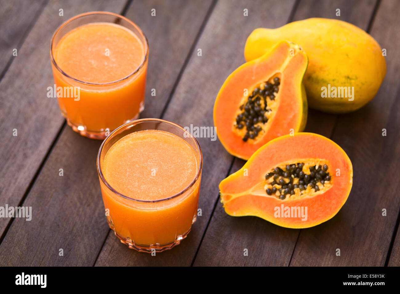 Two glasses of freshly prepared papaya juice with papaya fruits on the ...