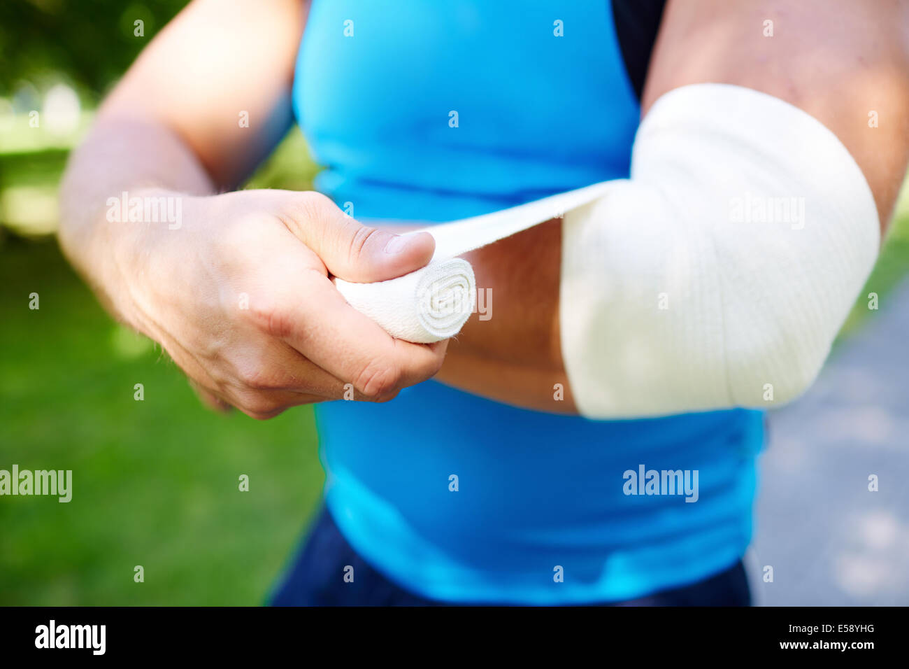 Close-up of male bandaging his arm Stock Photo - Alamy