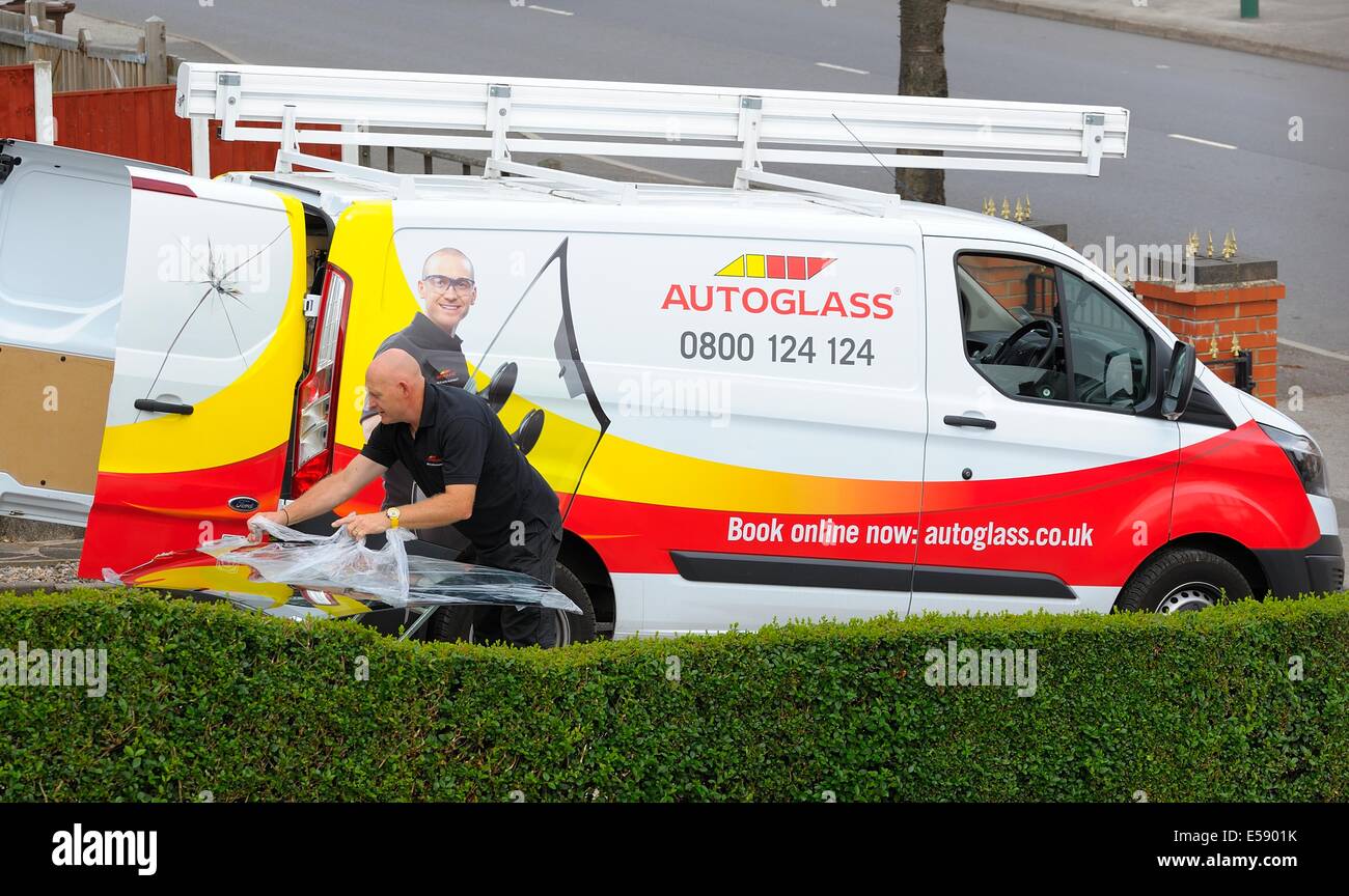 Autoglass van parked on a driveway replacing a damaged windscreen ...