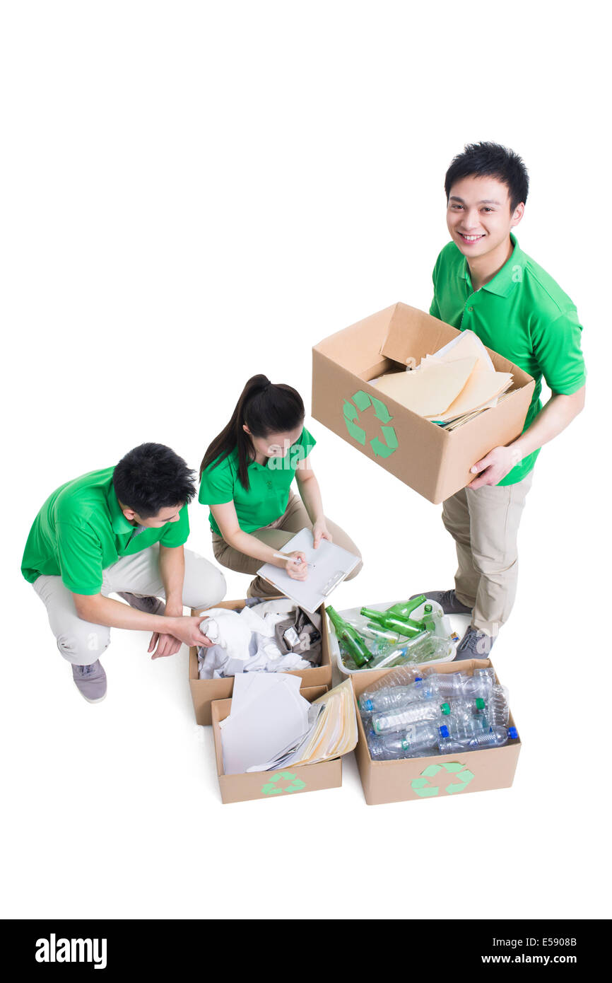 Happy volunteers recycling Stock Photo - Alamy