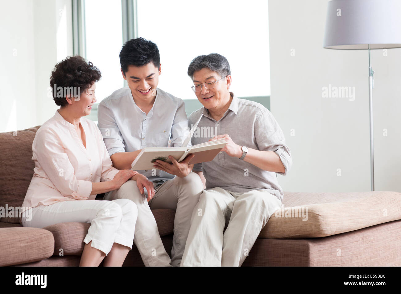 Mother son looking photo album hi-res stock photography and images - Alamy