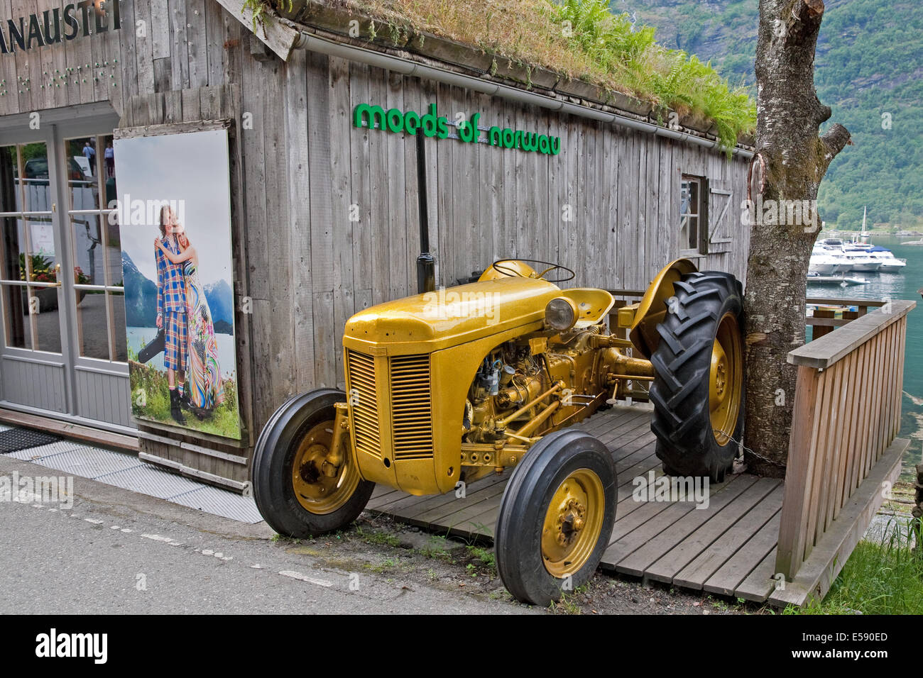 A gold coloured tractor in Geiranger Norway Stock Photo - Alamy