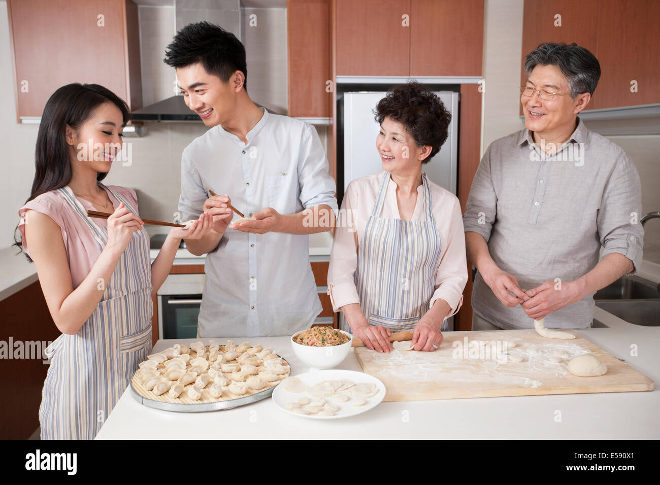 Happy family making dumplings Stock Photo - Alamy