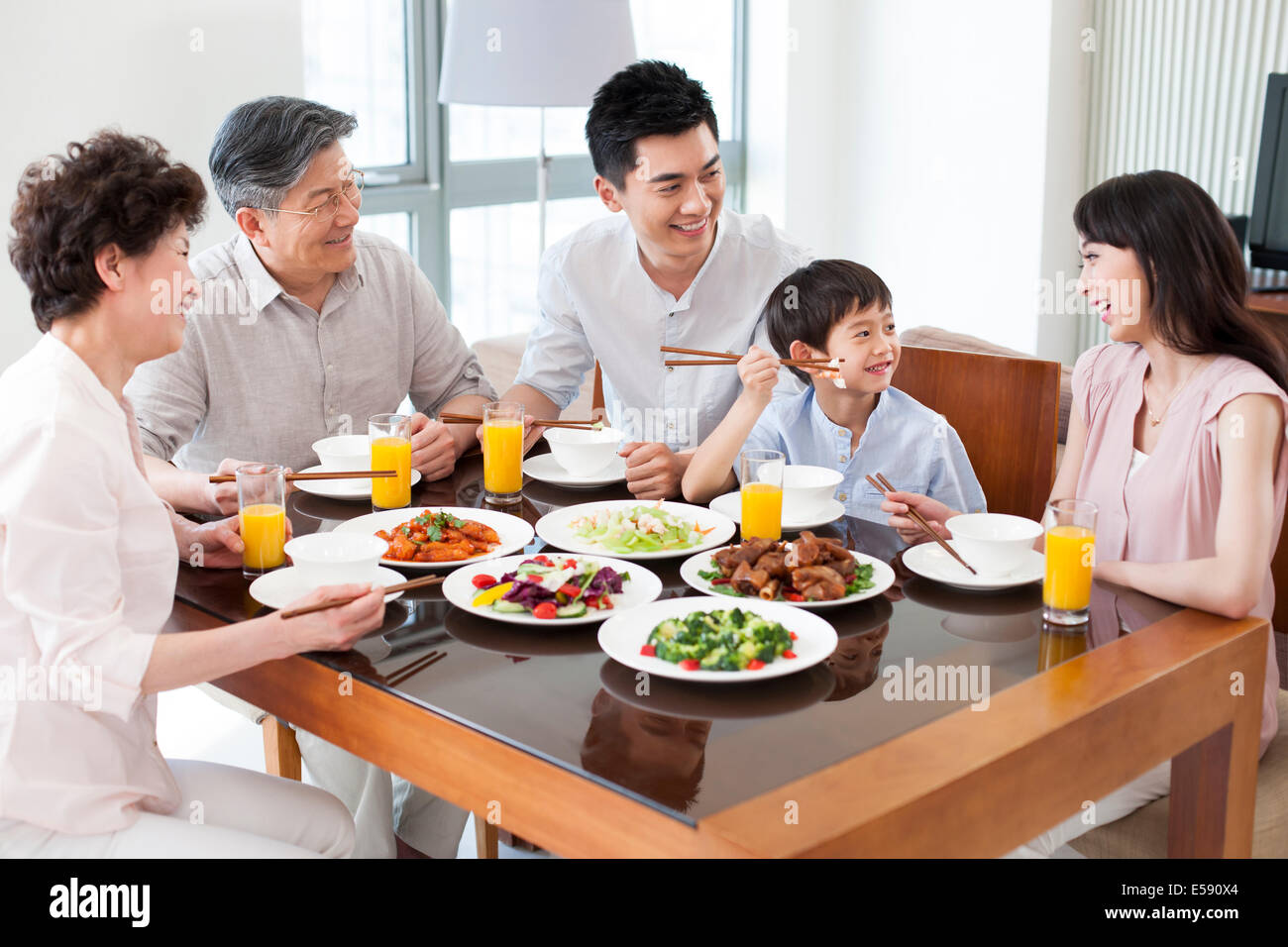 Happy family having lunch Stock Photo - Alamy