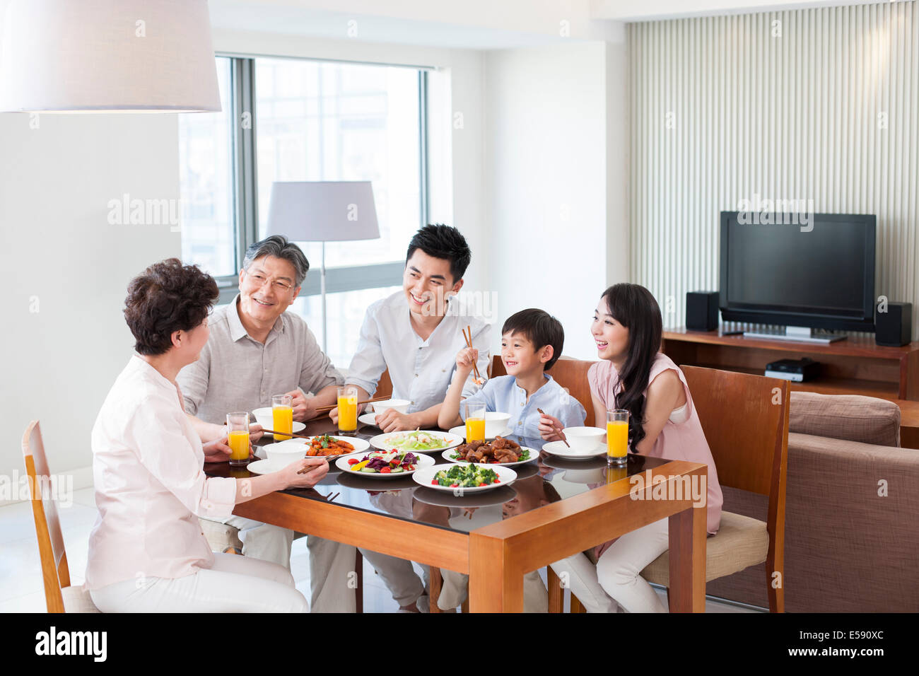 Happy family having lunch Stock Photo - Alamy