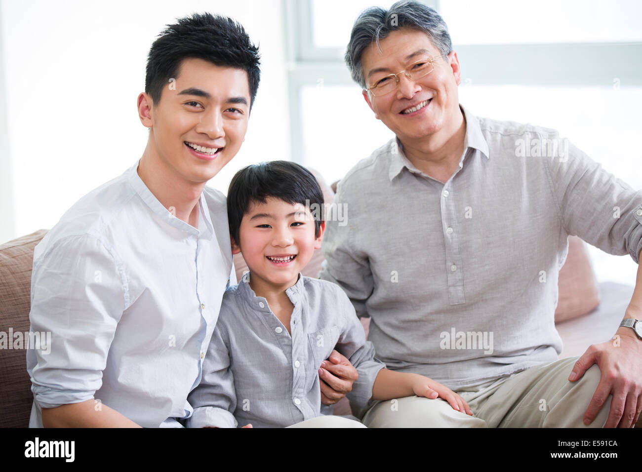 Happy three generations of men Stock Photo - Alamy