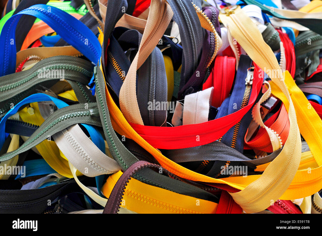 a pile of zippers of many sizes and colors Stock Photo - Alamy