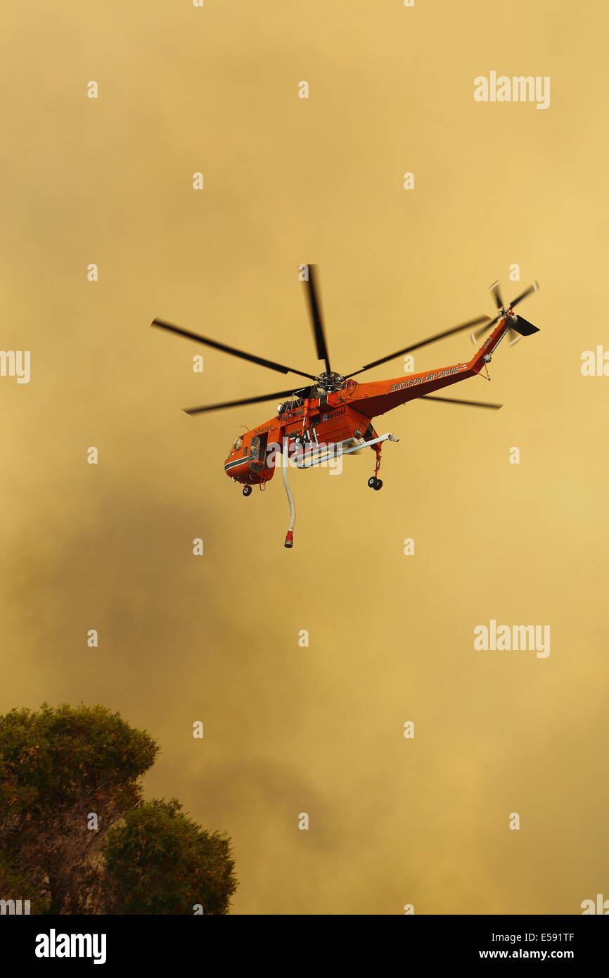 Aerial fire fighting a bush fire using water bomber helicopter in ...