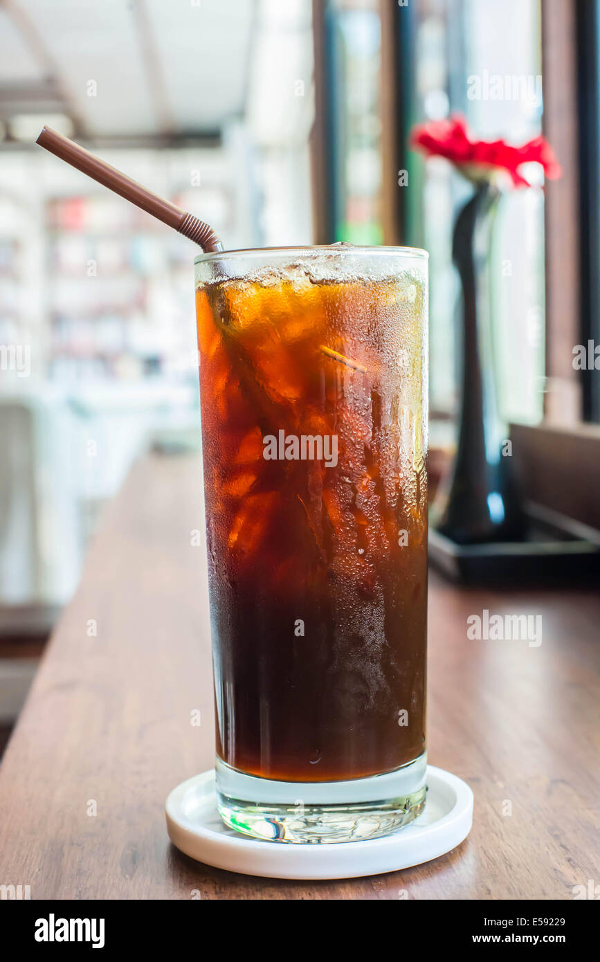 Iced black coffee on the wooden table in coffee cafe Stock Photo - Alamy