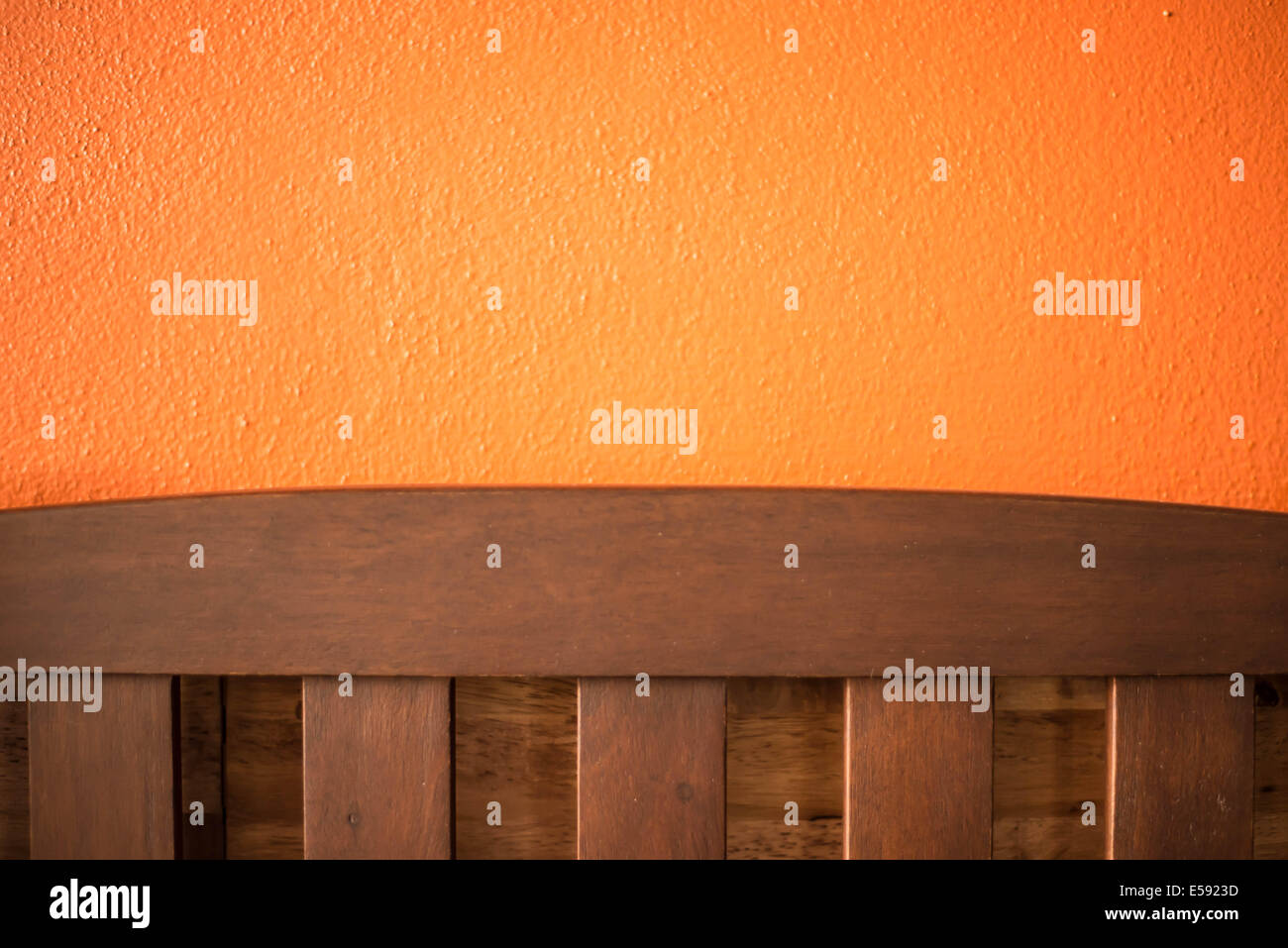 Backrest chair on the orange background in café Stock Photo - Alamy