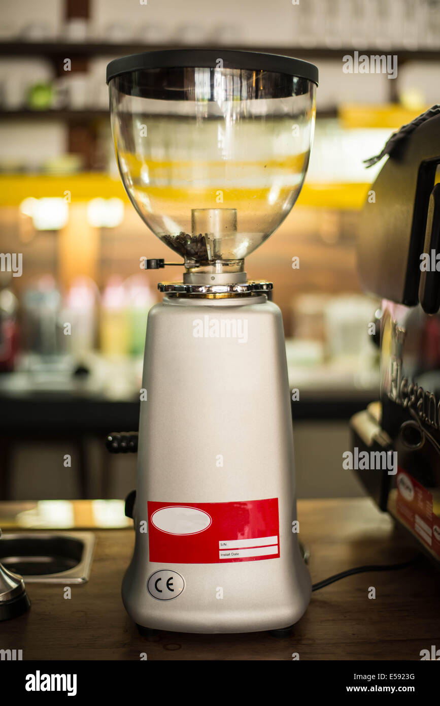 Coffee grinder on a wooden table in a coffee shop Stock Photo - Alamy