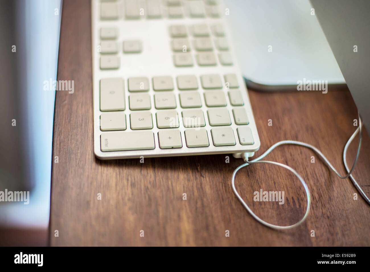 White keyboard on the wooden table Stock Photo - Alamy